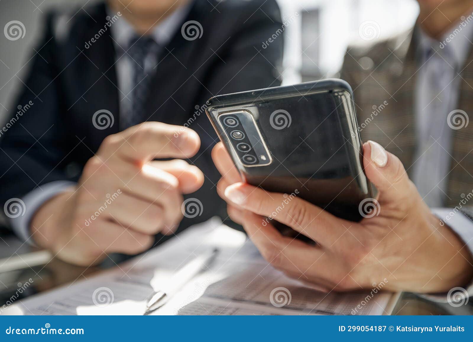 Manager Uses Smartphone while Sitting at Table with Colleague Stock ...