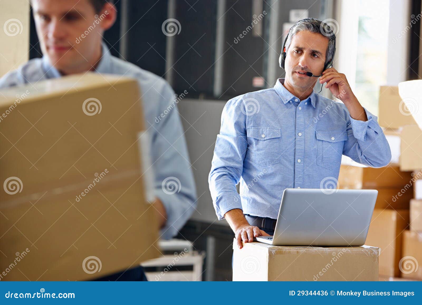 Manager Using Headset in Distribution Warehouse Stock Photo - Image of ...