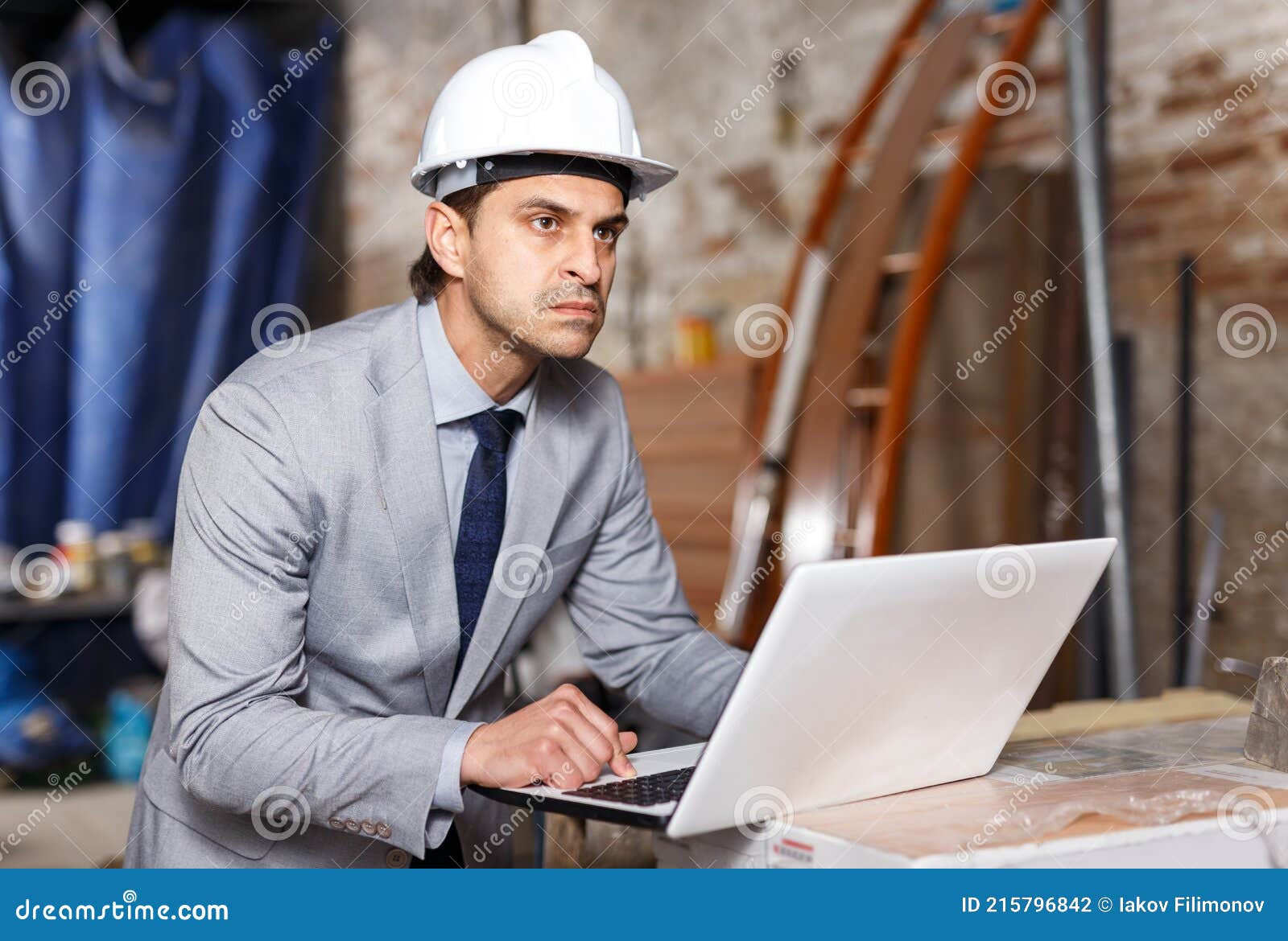 Manager Using Laptop with Blueprints Stock Photo - Image of computer ...