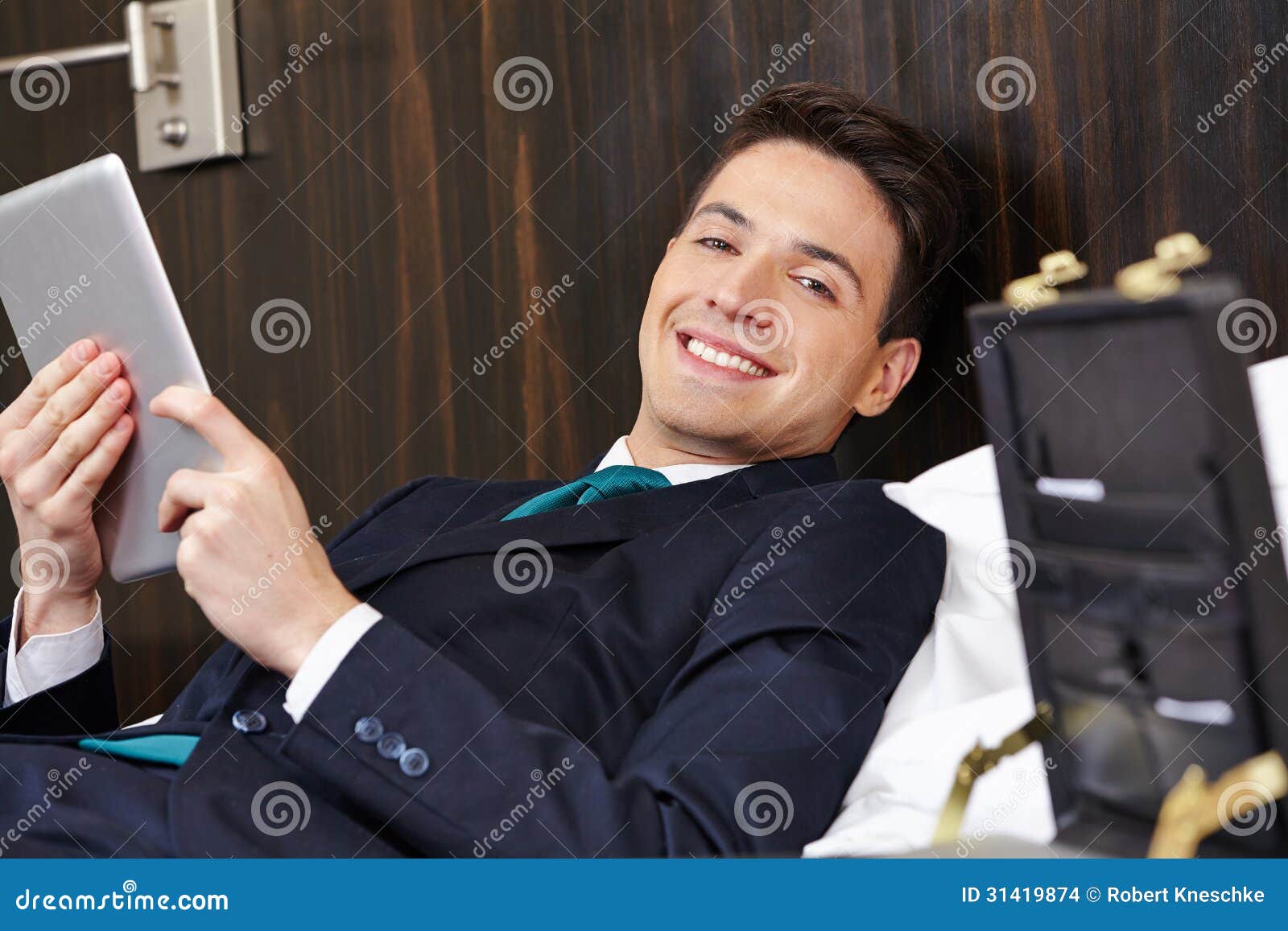 Manager Using Tablet Computer in Hotel Bed Stock Photo - Image of ...