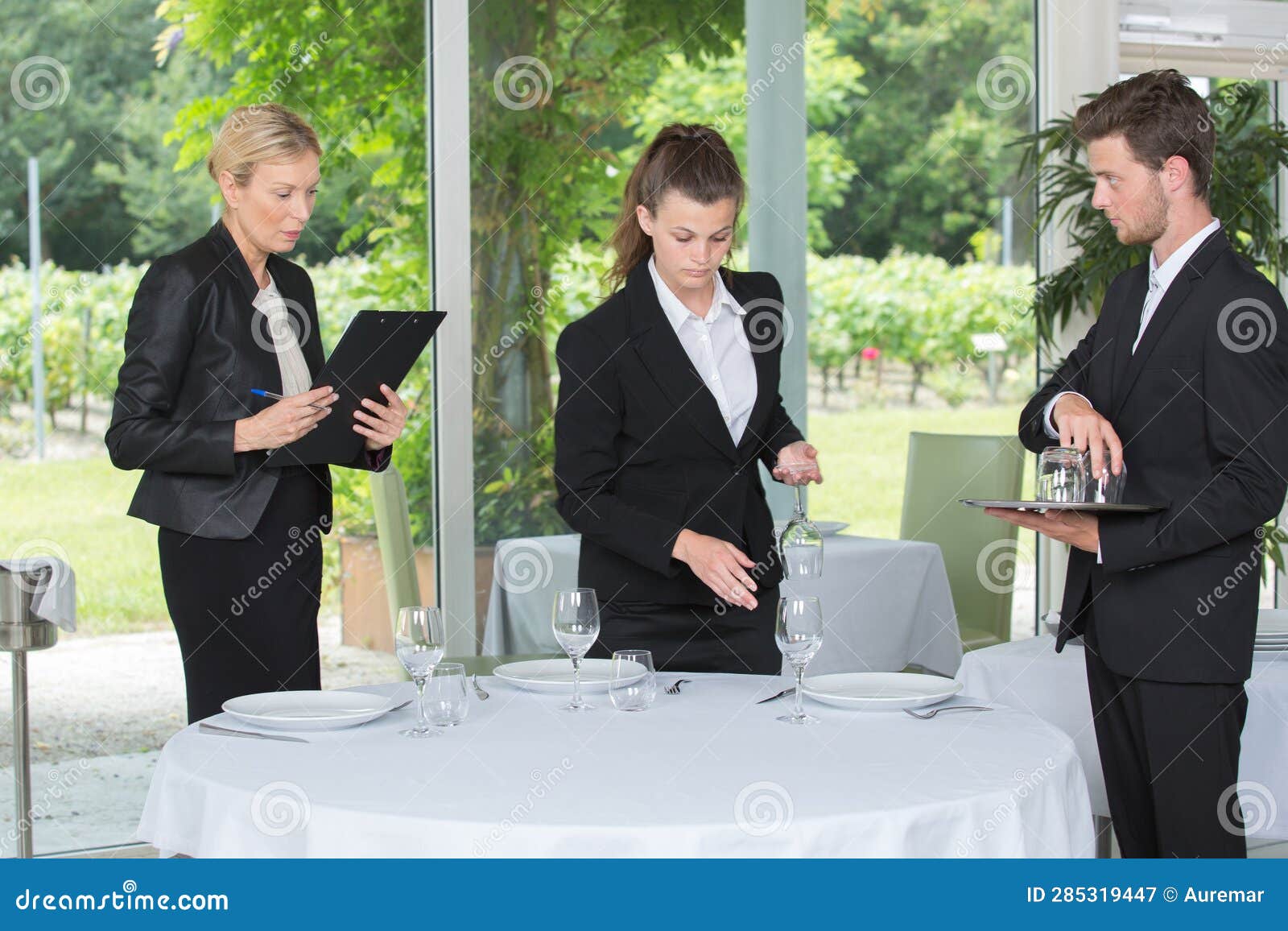 Manager Watching Waiting Staff Set Table Stock Image - Image of laying ...
