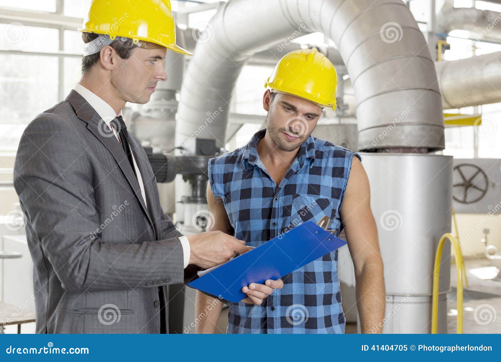 Manager with Worker Discussing Over Clipboard in Industry Stock Image ...