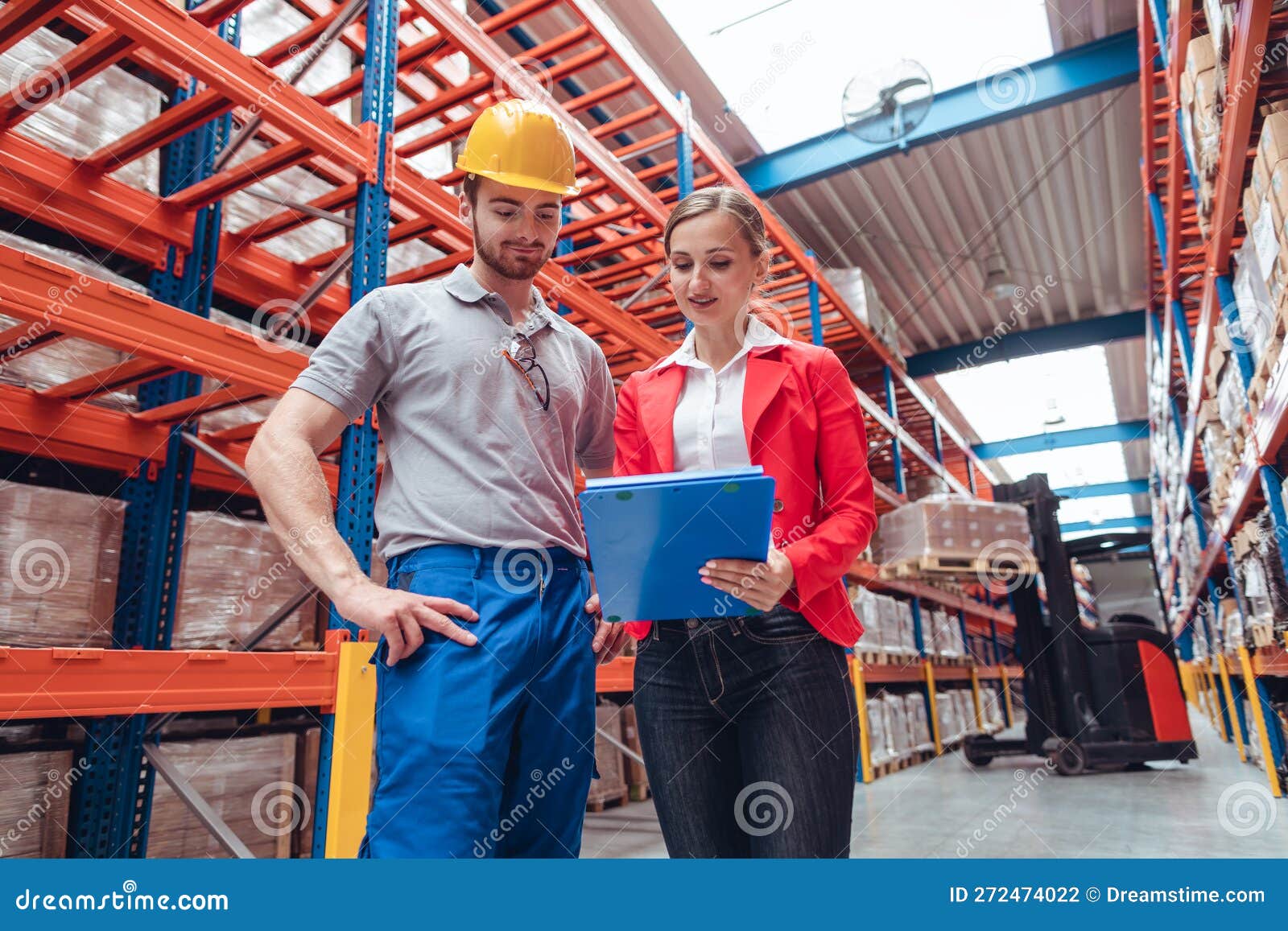Manager and Worker in High Bay Warehouse Discussing Business Stock ...
