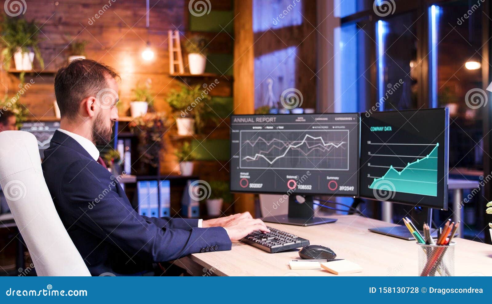 Manager Working on Financial Data on Two Monitors Setup Stock Photo ...