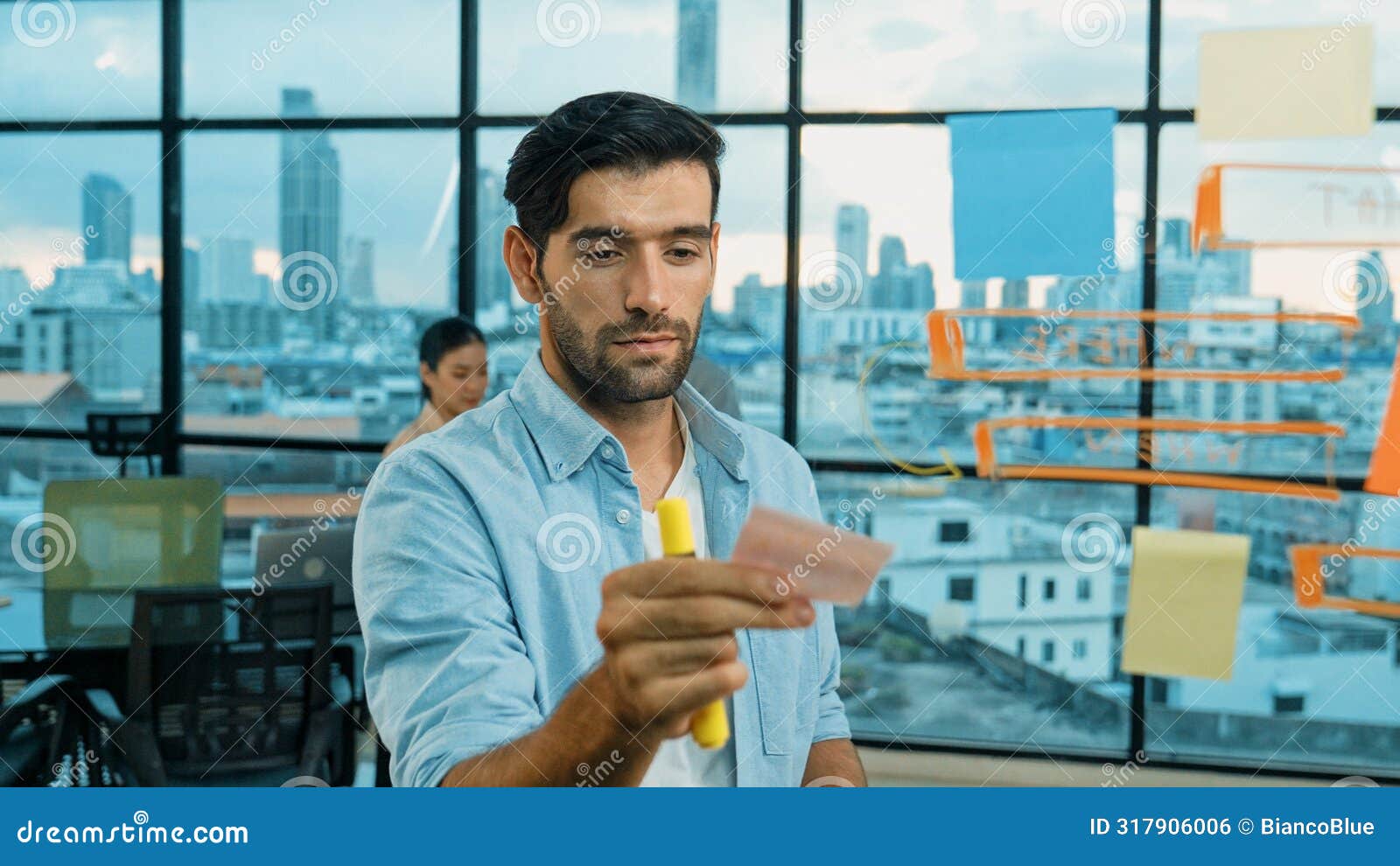 Manager Writing Sticky Notes at Glass Wall To Planing Strategy. Tracery ...