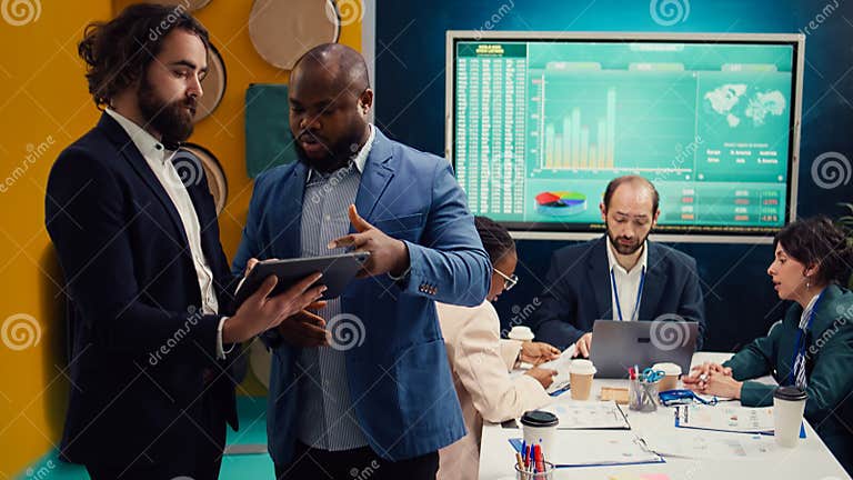 Managers Examining Infographics To Provide Input on an Issue Affecting Project Stock Photo ...