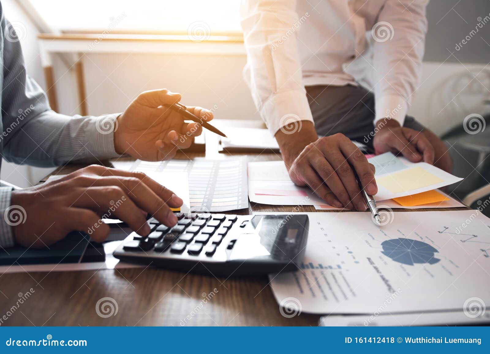 Managers Using Calculator To Analyze Sales Cost Reports and Explain ...