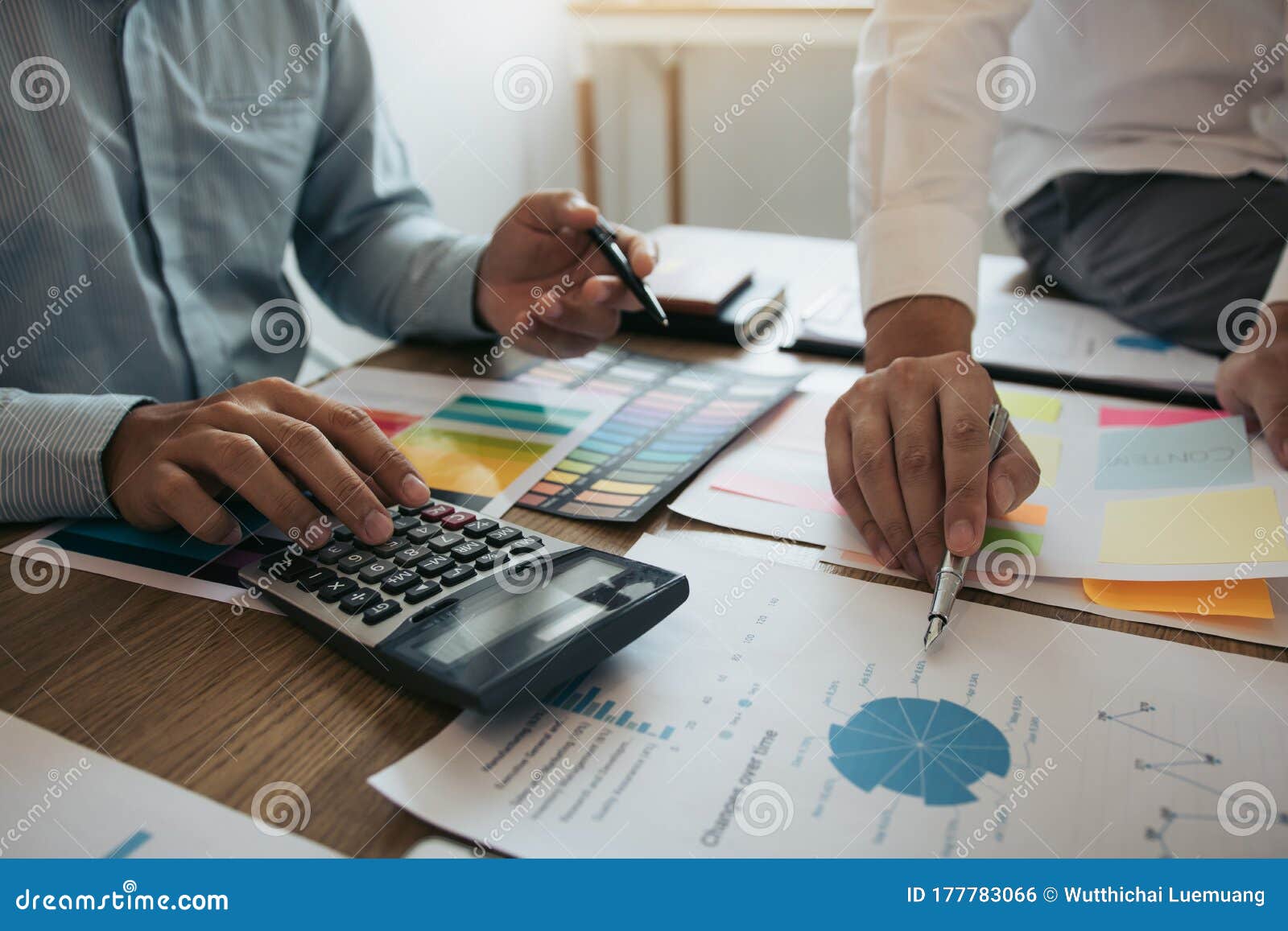Managers Using Calculator To Analyze Sales Cost Reports and Explain ...