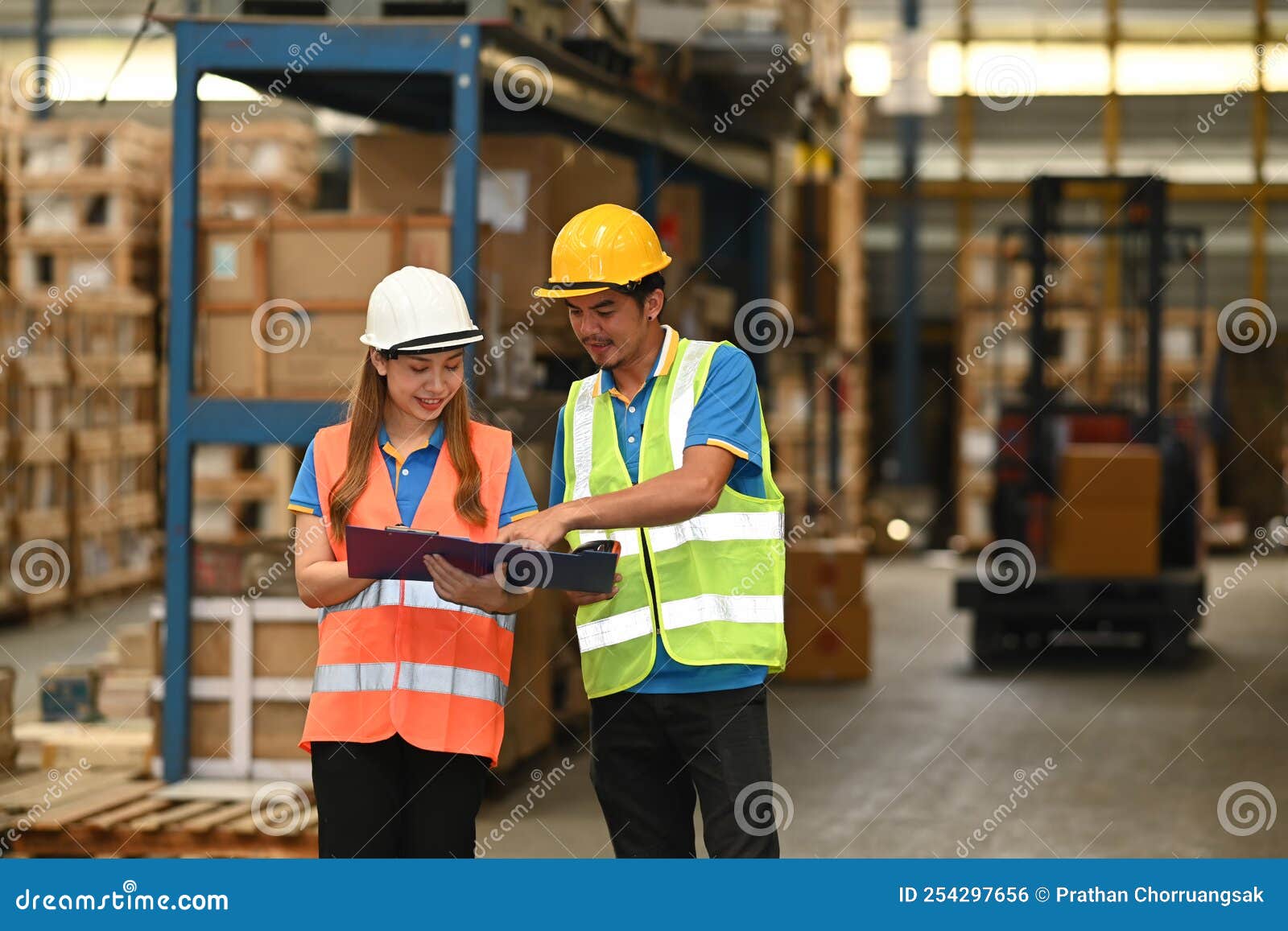 Managers and Warehouse Worker Checking Inventory in a Warehouse with ...