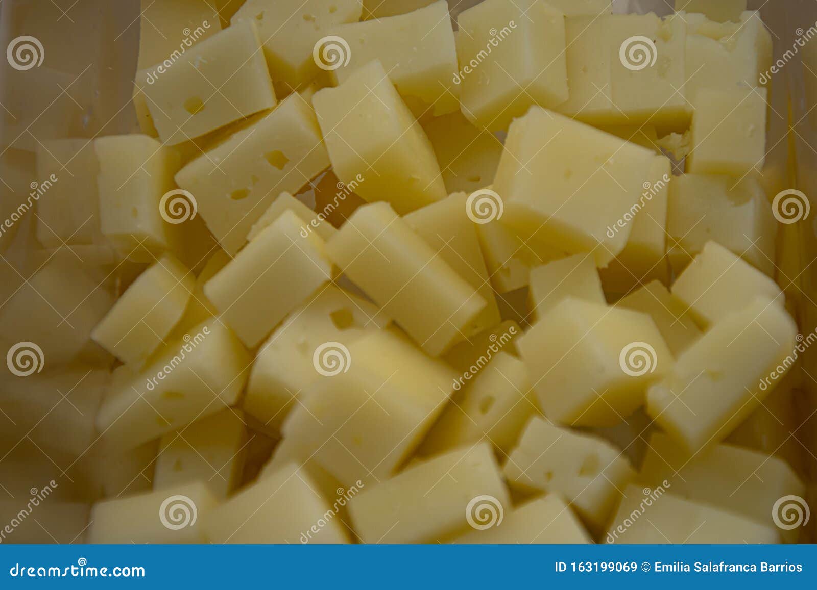 Manchego Cheese Split into Square Pieces for Tasting in the Foreground ...