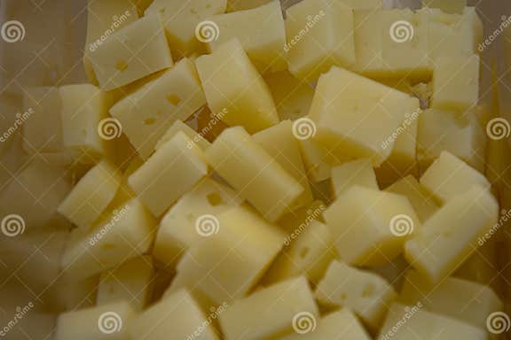 Manchego Cheese Split into Square Pieces for Tasting in the Foreground ...