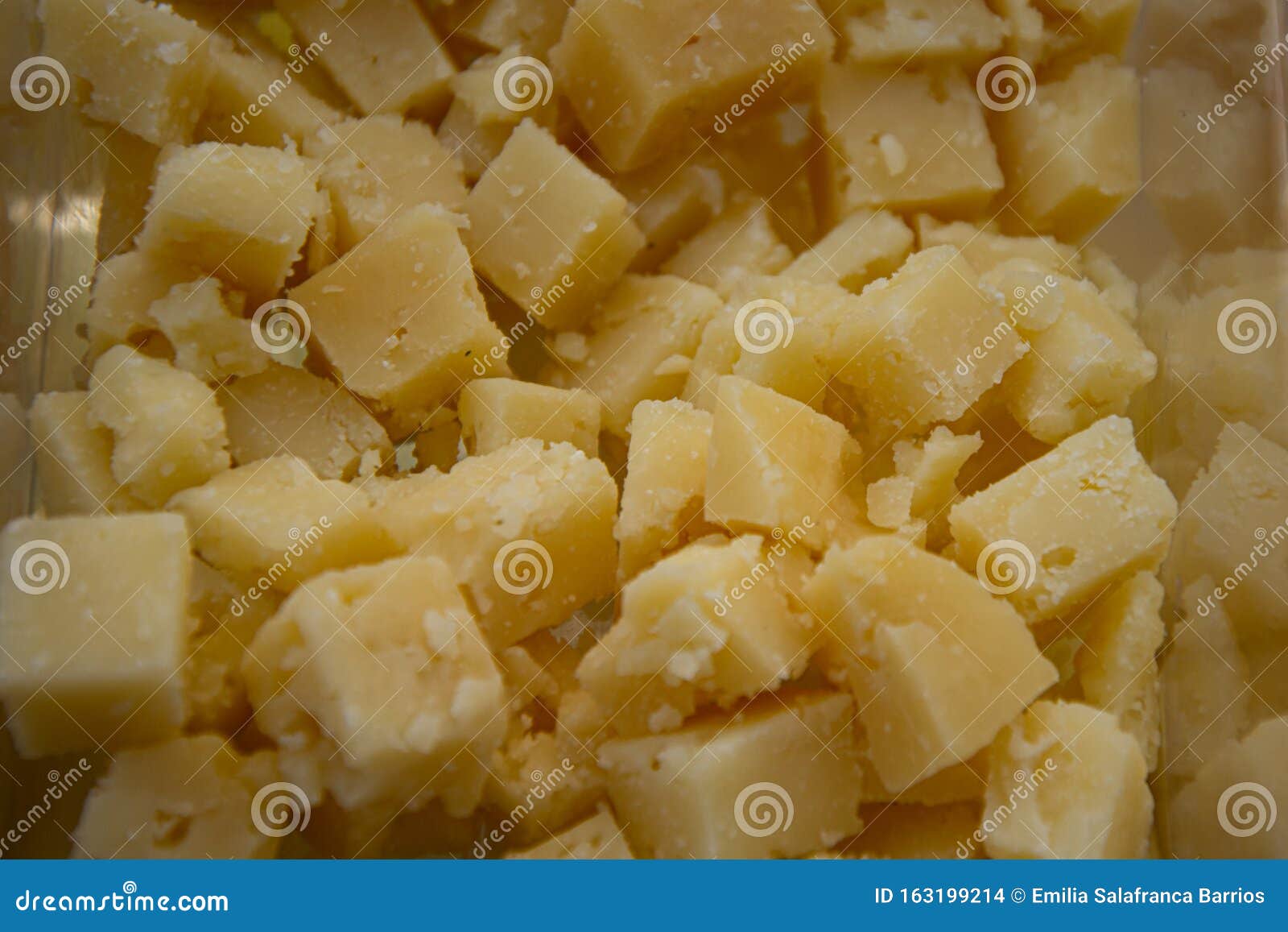 Manchego Cheese Split into Square Pieces for Tasting in the Foreground ...