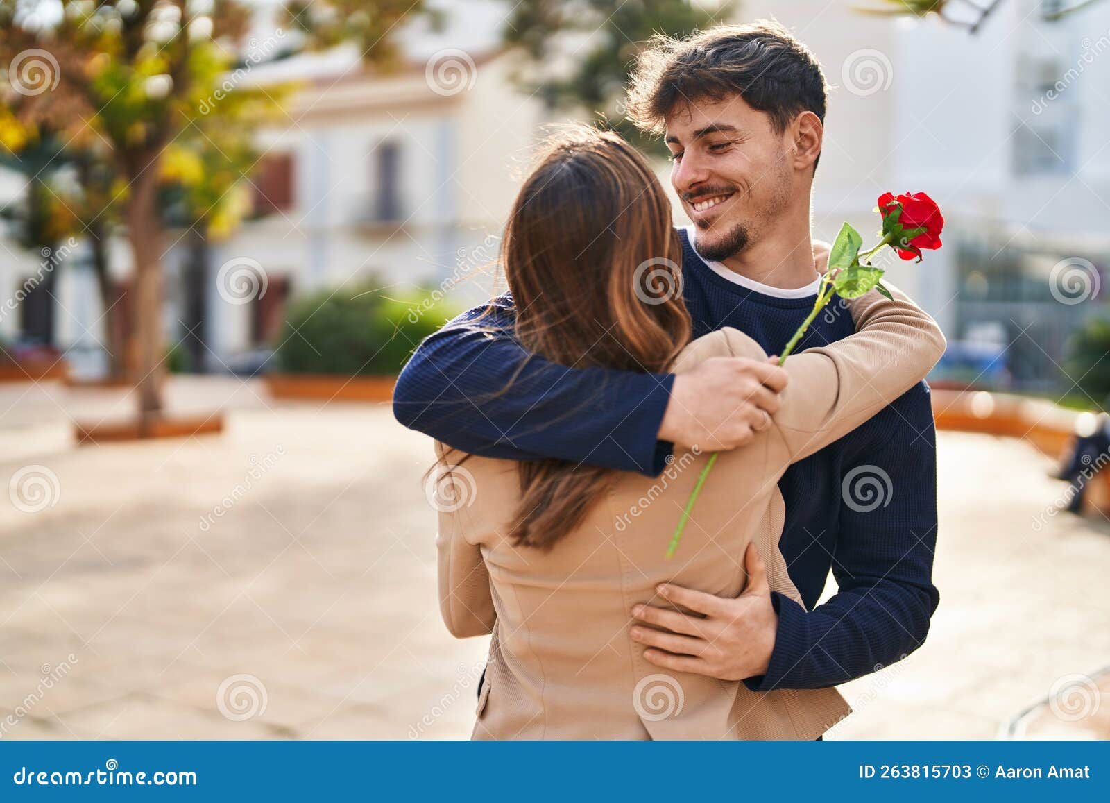 Mand And Woman Couple Hugging Each Other Suprise With Rose At Park