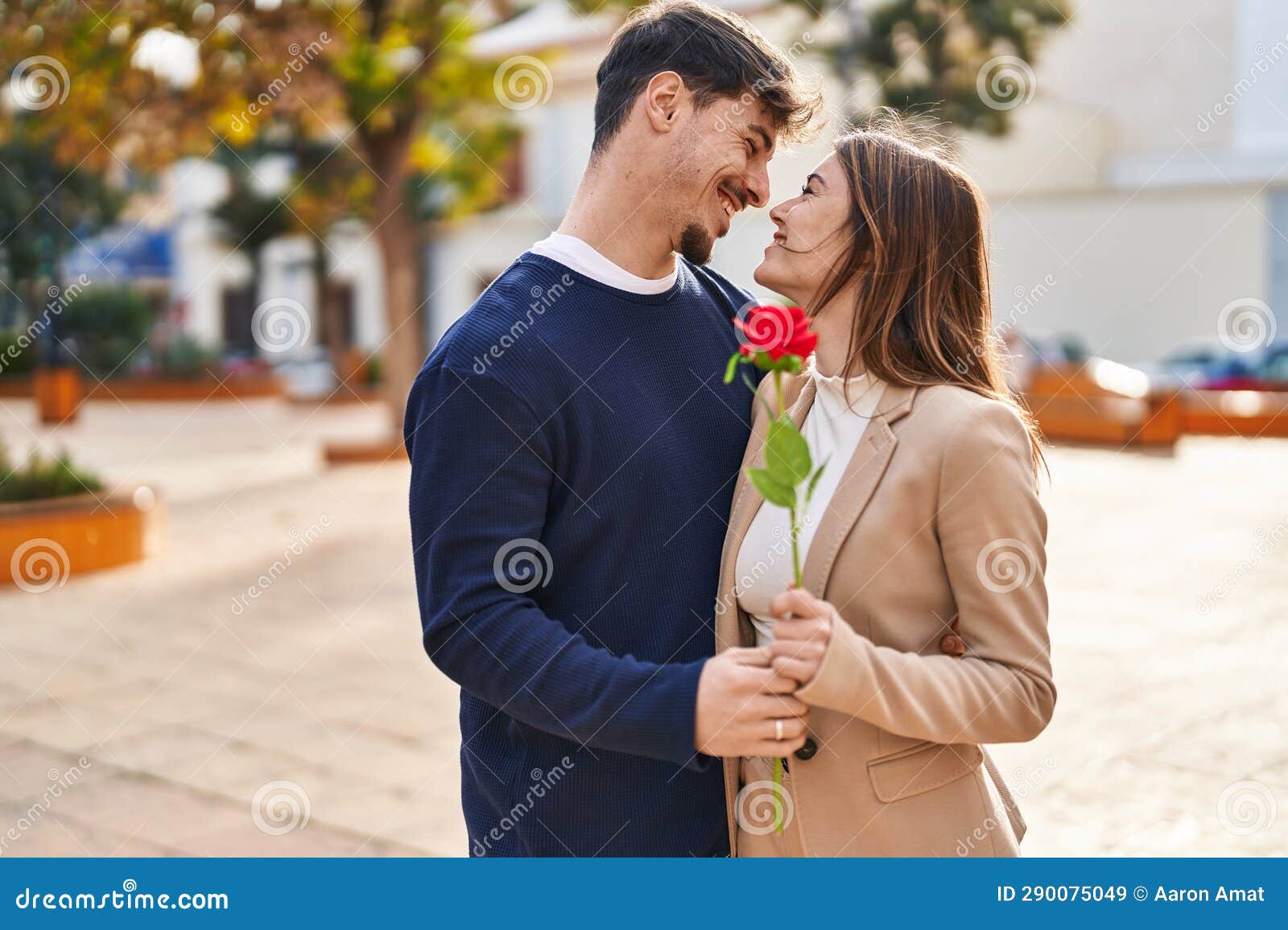 Mand And Woman Couple Suprise With Rose Standing Together At Park Stock
