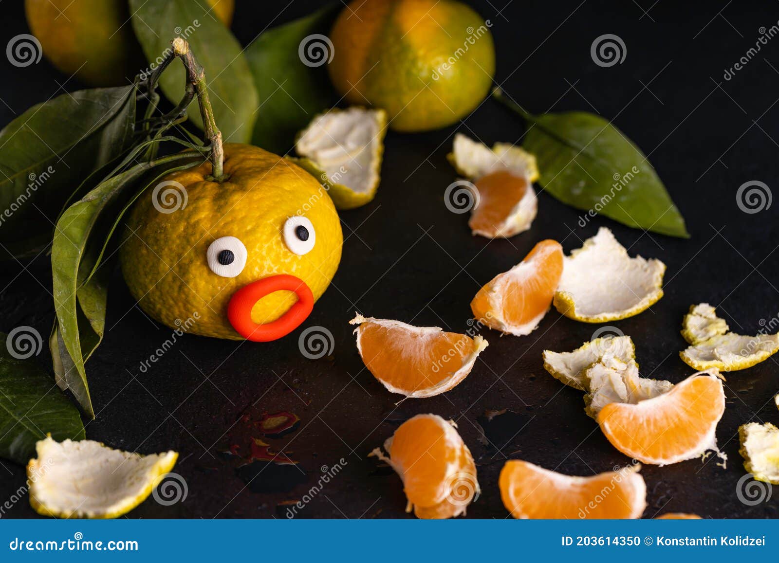 Mandarin with funny face. stock photo. Image of orange - 203614350