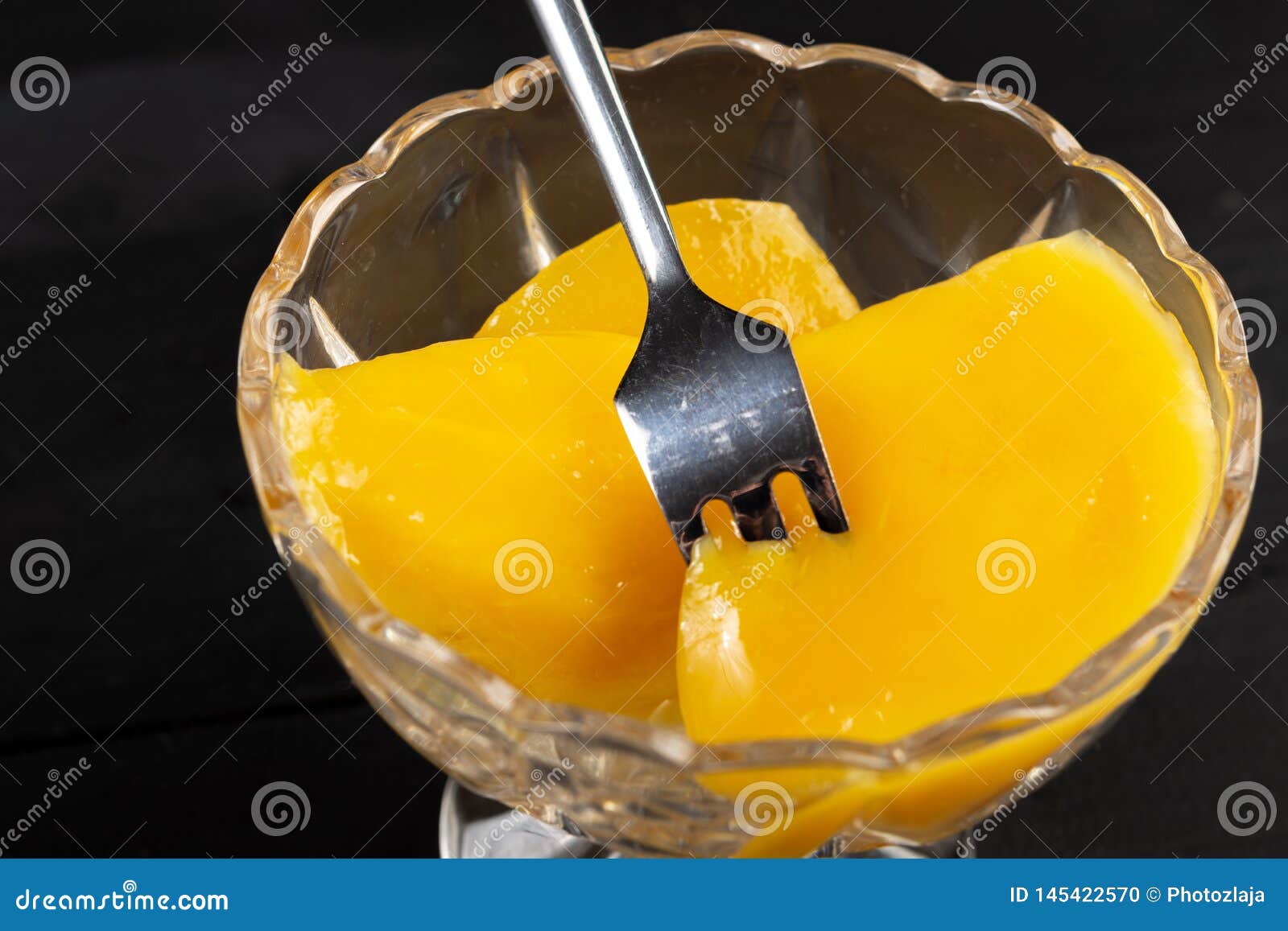 Mango Compote in the Crystal Bowl Above Black Background Stock Photo ...