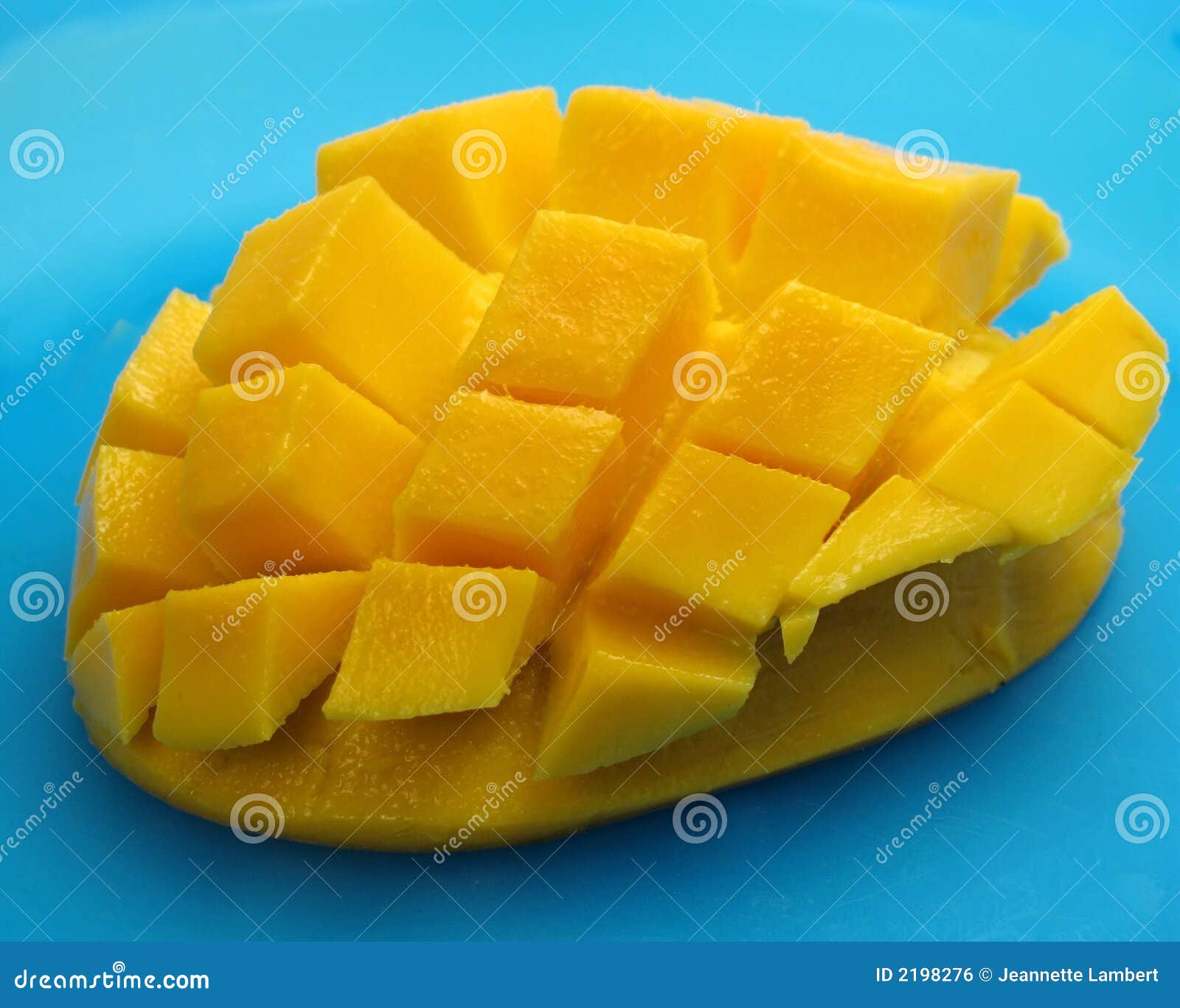 Mango in cubes on blue stock photo. Image of dessert, fresh - 2198276