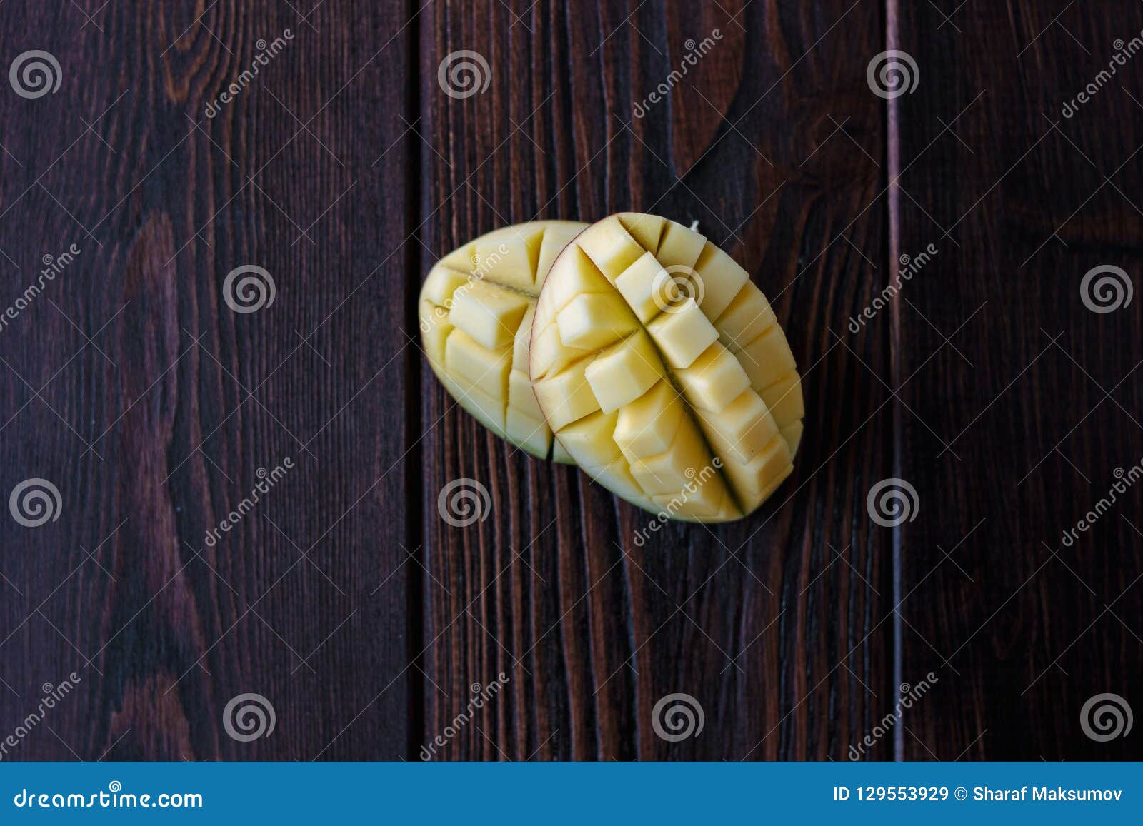 Mango Halves. Two Pieces of Fresh Mango Fruit Over Wooden Table. Stock ...