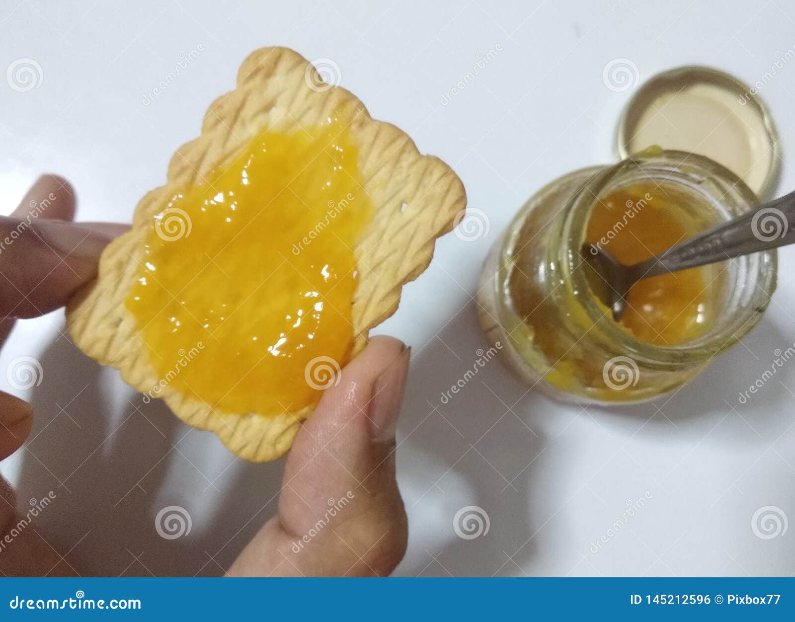 Mango jam on cracker stock photo. Image of eating, finger - 145212596