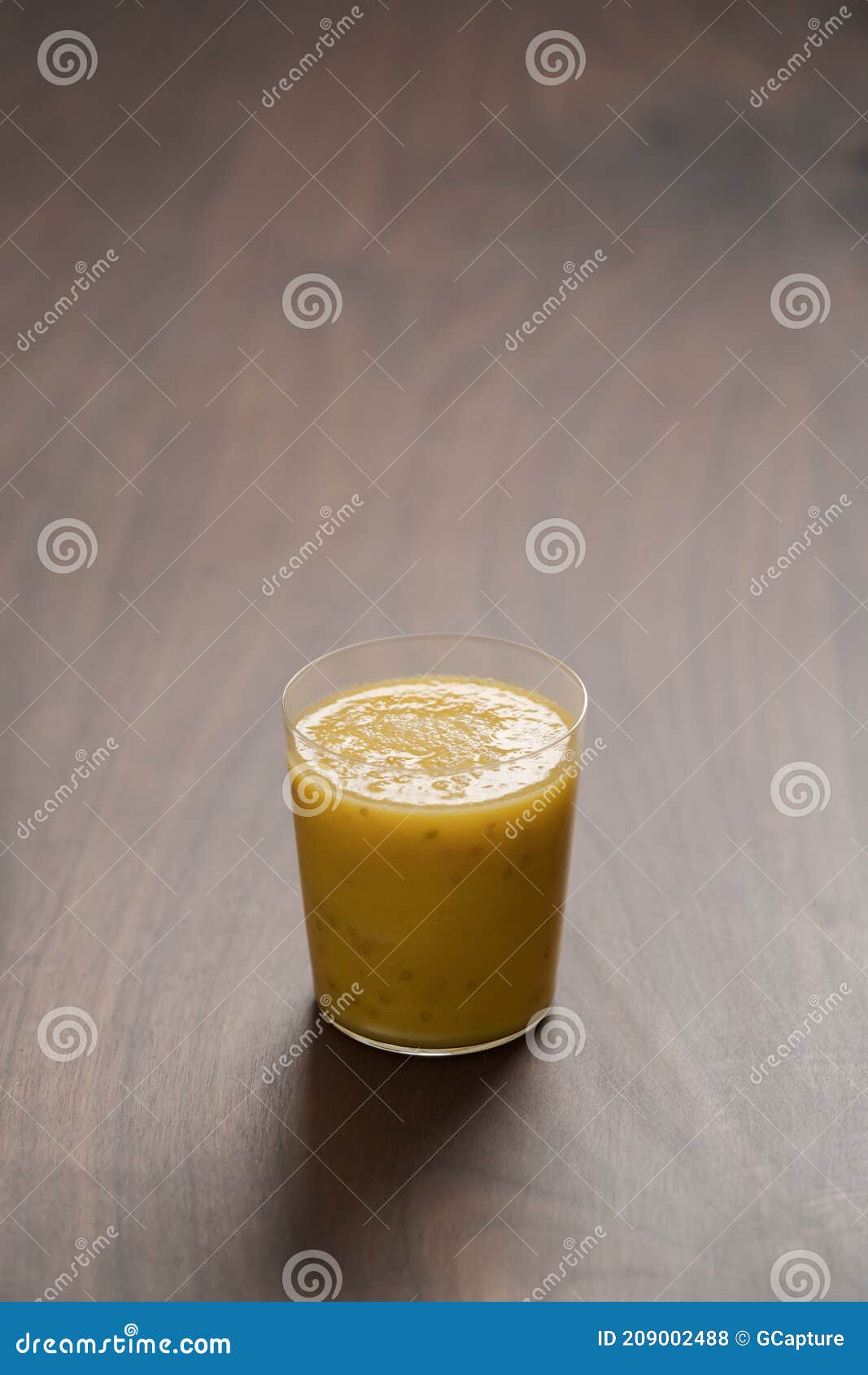 Mango Lulo Smoothie on Walnut Wood Table with Copy Space Stock Photo ...