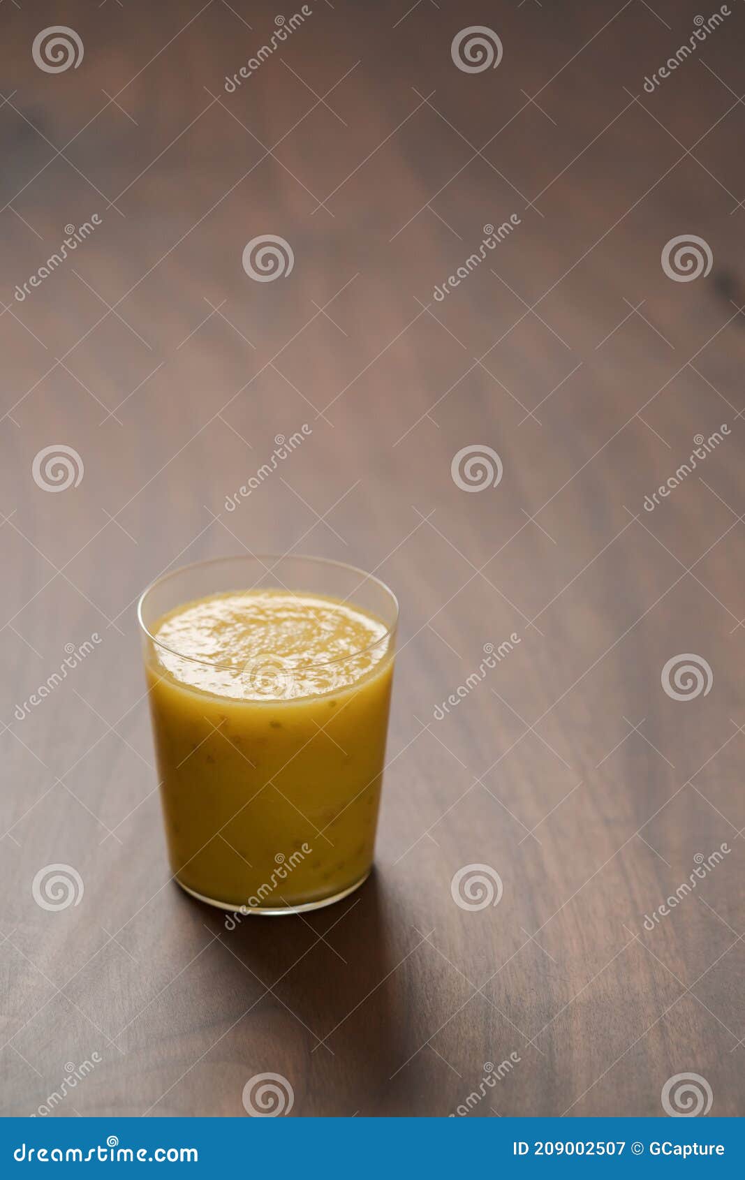 Mango Lulo Smoothie on Walnut Wood Table with Copy Space Stock Image ...