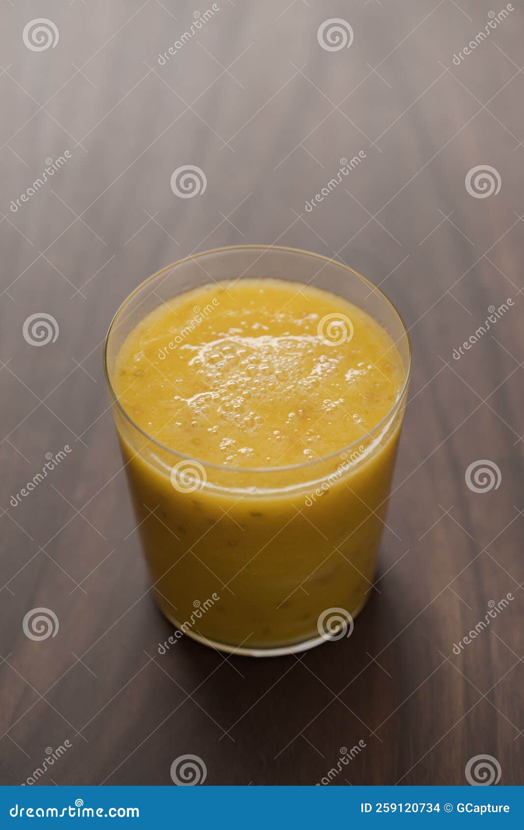 Mango Lulo Smoothie on Walnut Wood Table with Copy Space Stock Photo ...