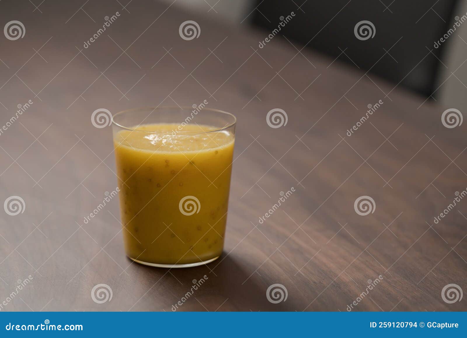 Mango Lulo Smoothie on Walnut Wood Table with Copy Space Stock Photo ...