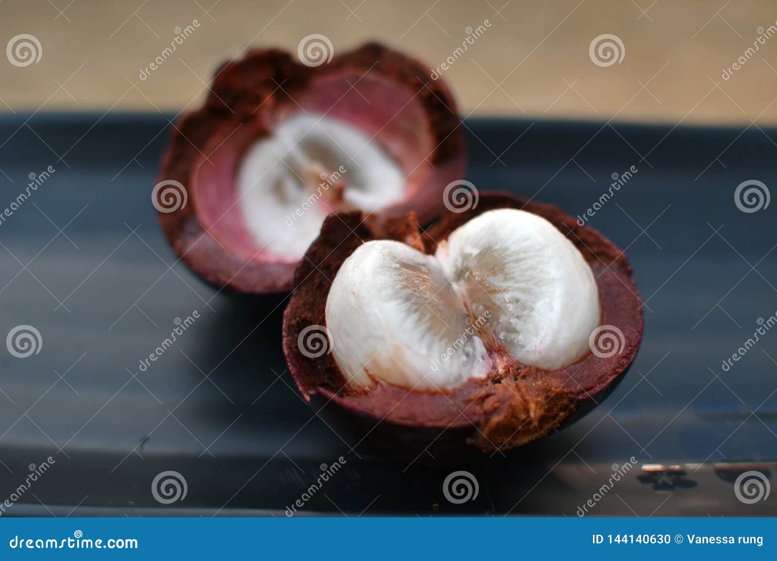 Mangostin in a black plate stock photo. Image of beverage - 144140630