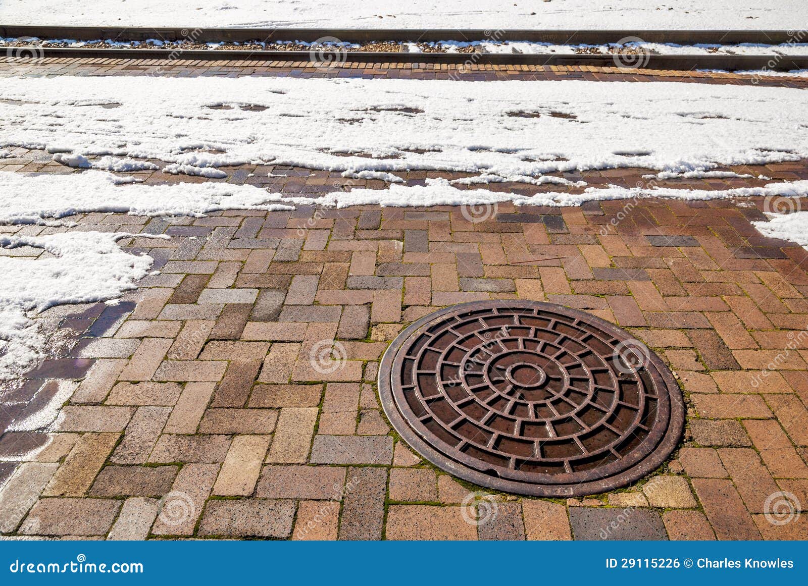 Manhole Cover with Bricks and Railroad Tracks Stock Photo - Image of ...