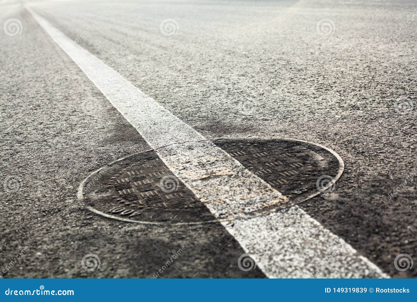 Manhole cover on the road stock image. Image of centre - 149319839