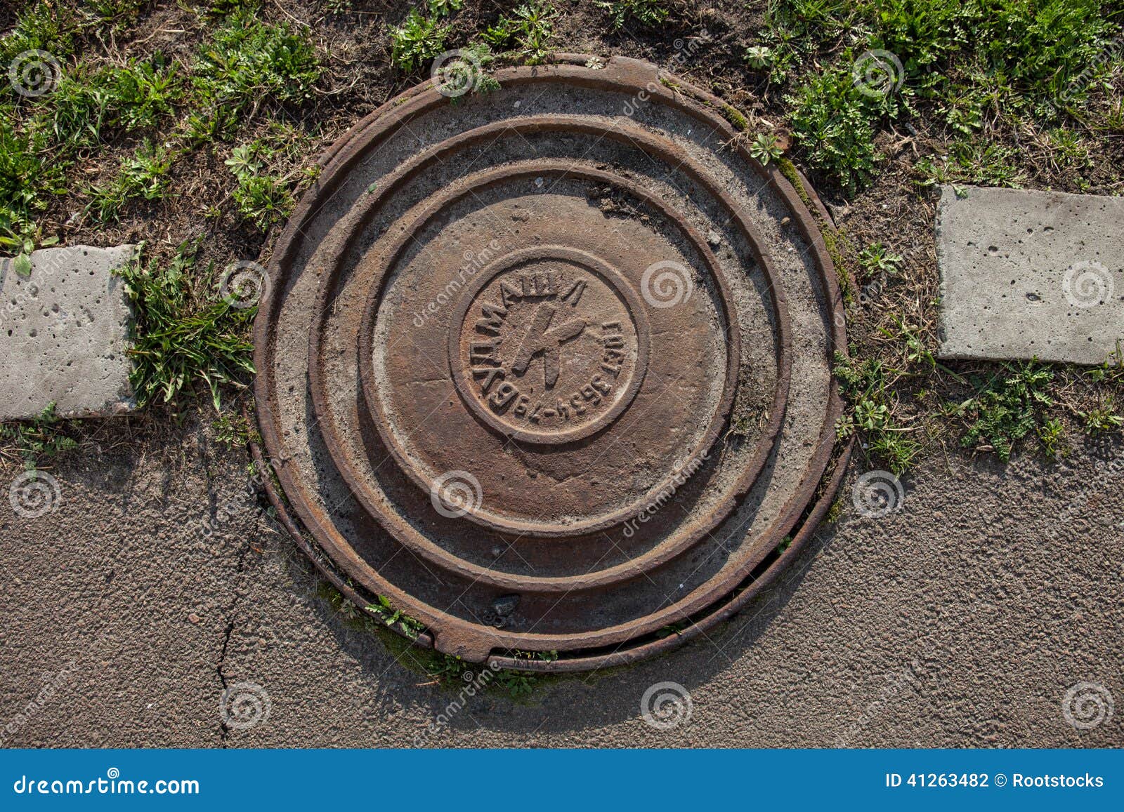 Manhole in the Curb Line between the Grass and Asphalt Stock Photo ...