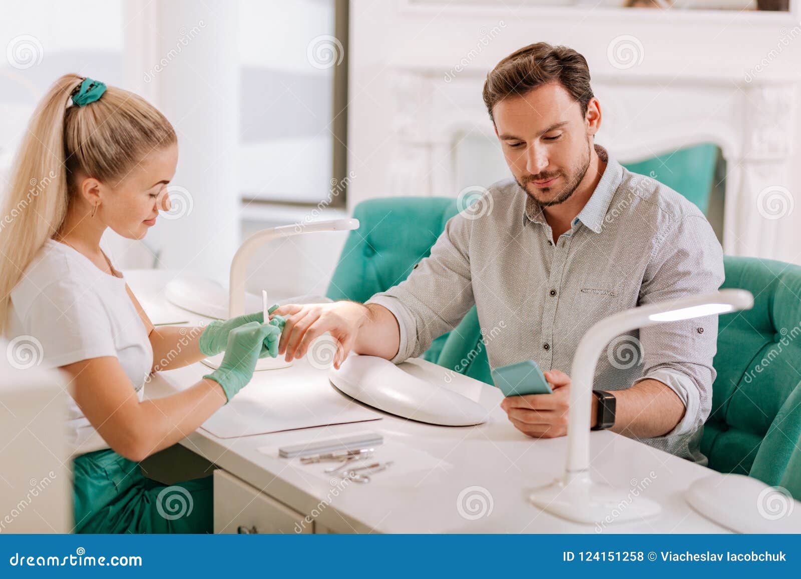 Blonde-haired Nail Master Using File Making Manicure for Man Stock ...