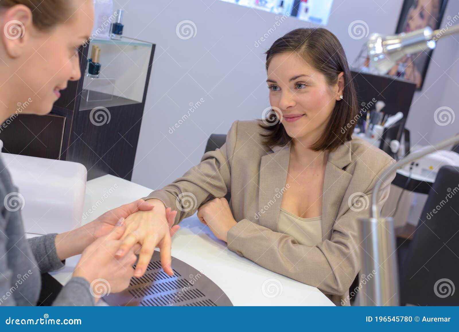 Manicurist Inspecting Clients Nails Stock Photo - Image of nail, modern ...