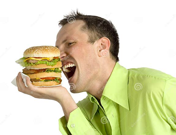 Mann isst Hamburger stockfoto. Bild von gaststätte, diät - 1084460