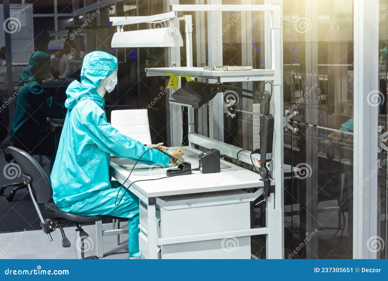 A Mannequin of a Man in a Protective Suit Sits at a Computer Stock ...