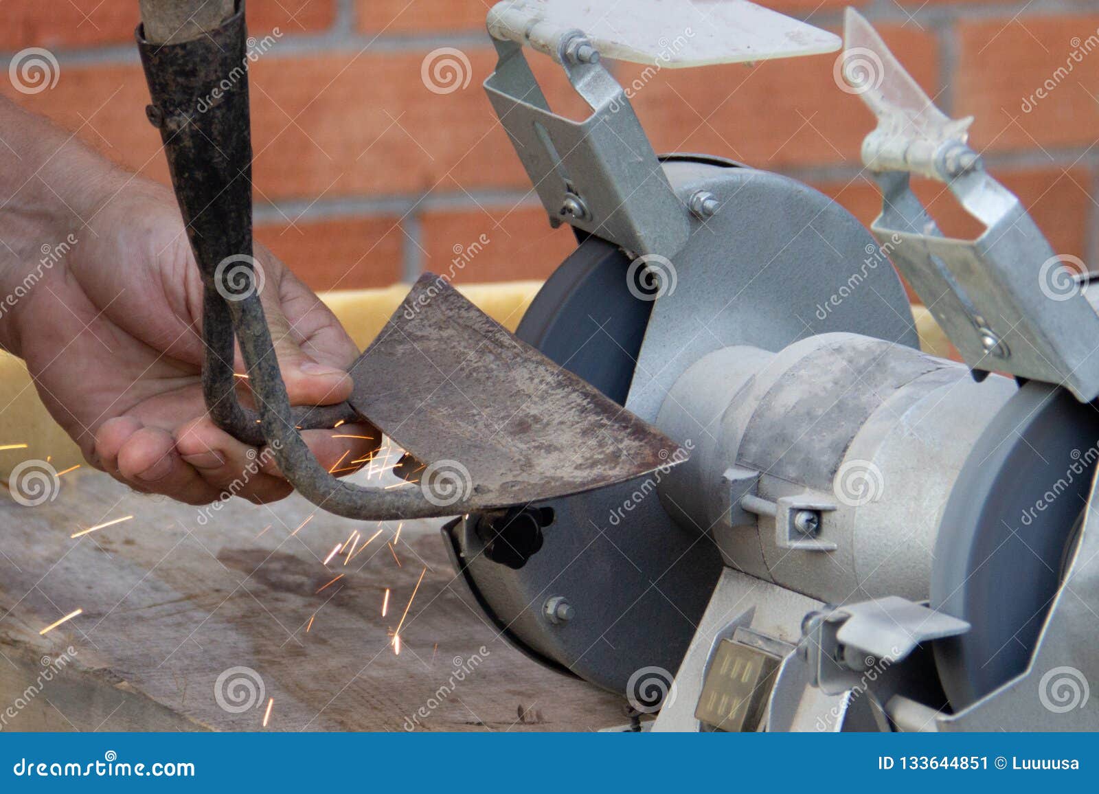 Mans Hand Sharpens a Hoe on Electric Grindstone in Rural Shed Stock ...