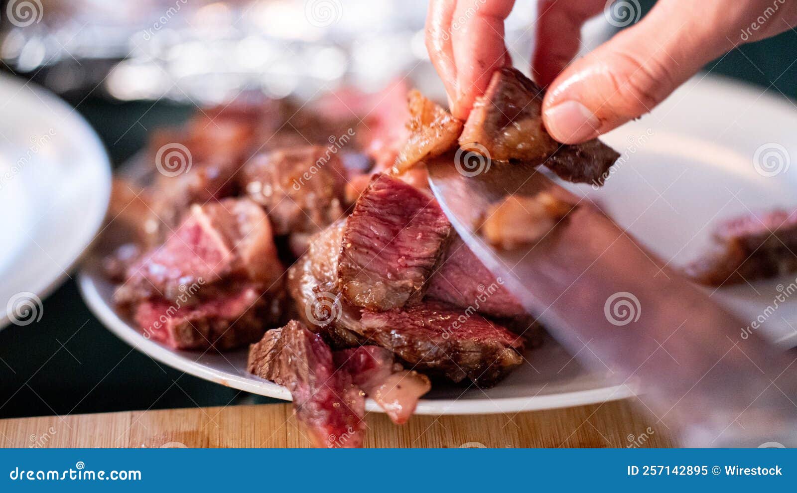 Mans hand slicing a meat stock image. Image of barbecue - 257142895