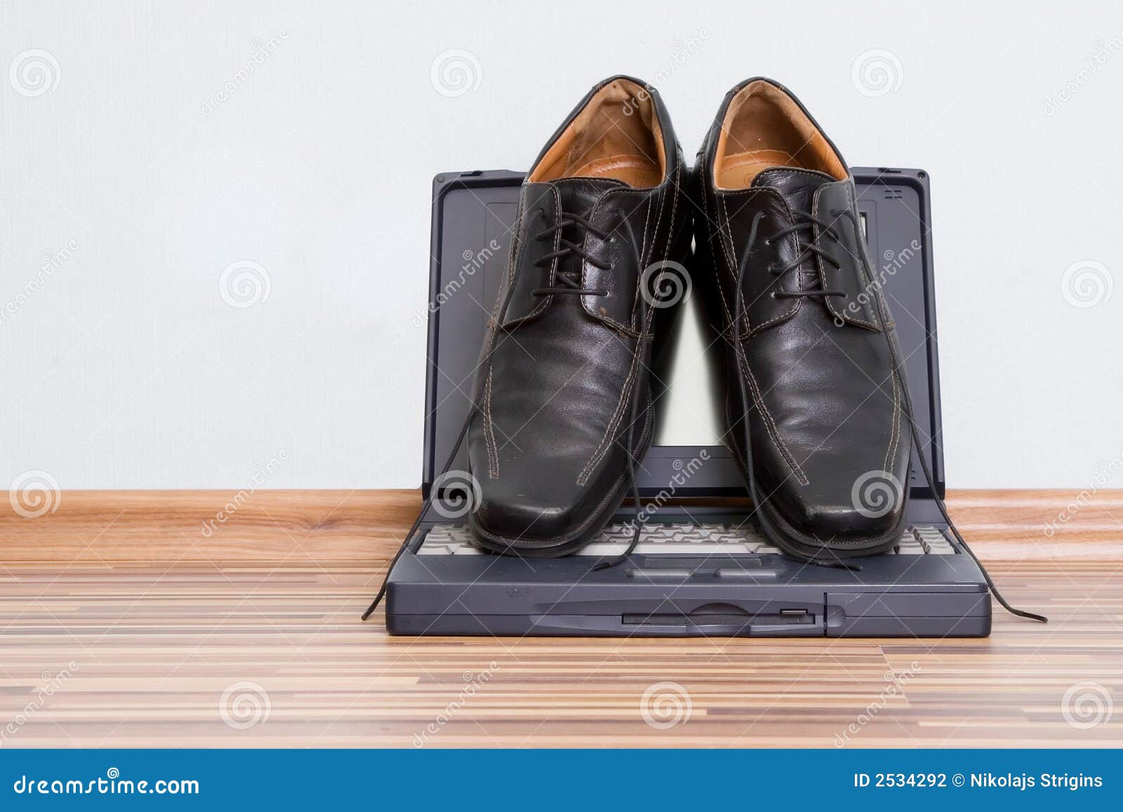 Mans shoes on the notebook stock photo. Image of boot - 2534292