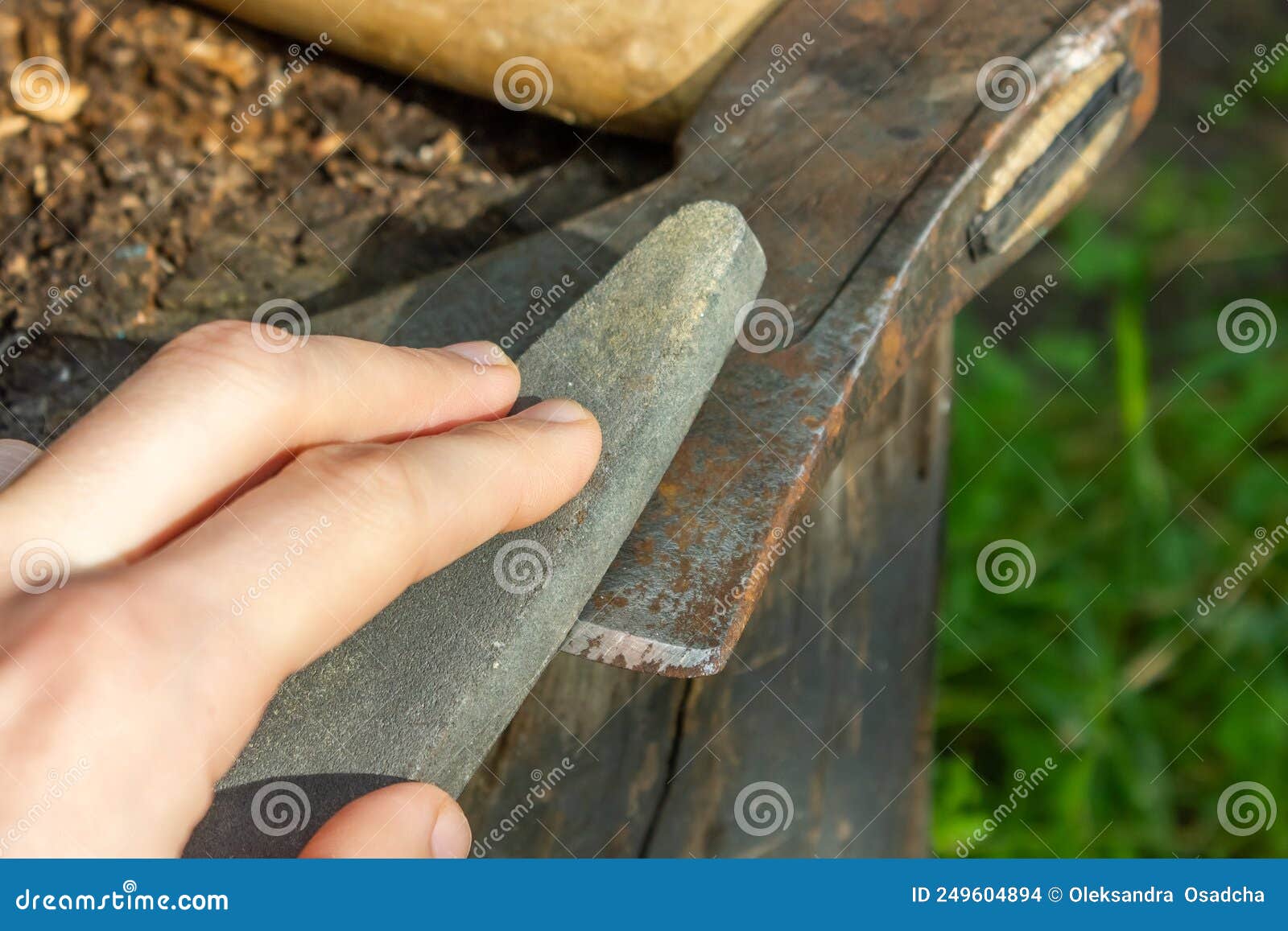 Manual Sharpening of an Axe. Grinding Stone in the Hands of the Master ...