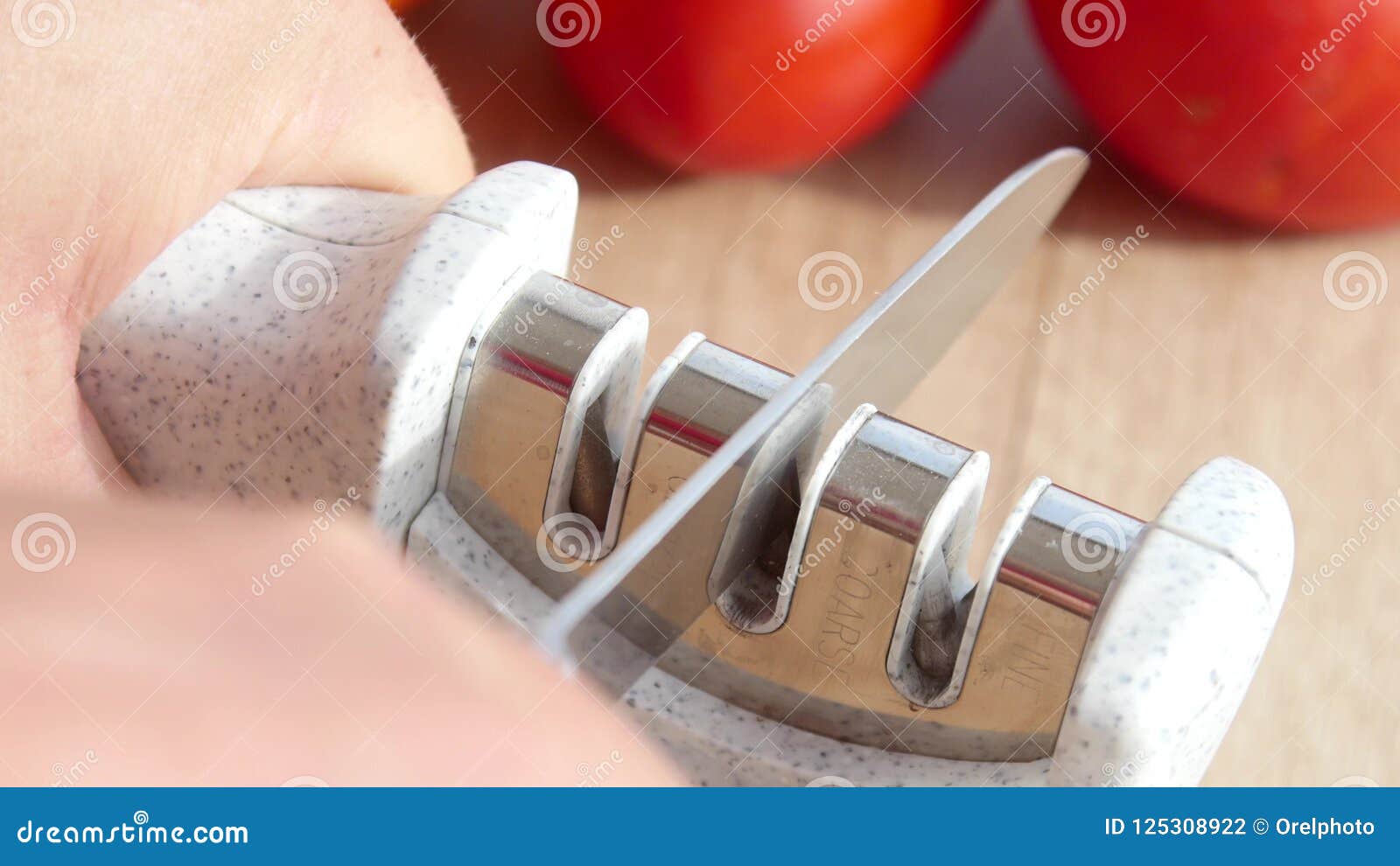 Manual Sharpening of a Knife in a Special Sharpener Stock Photo - Image ...