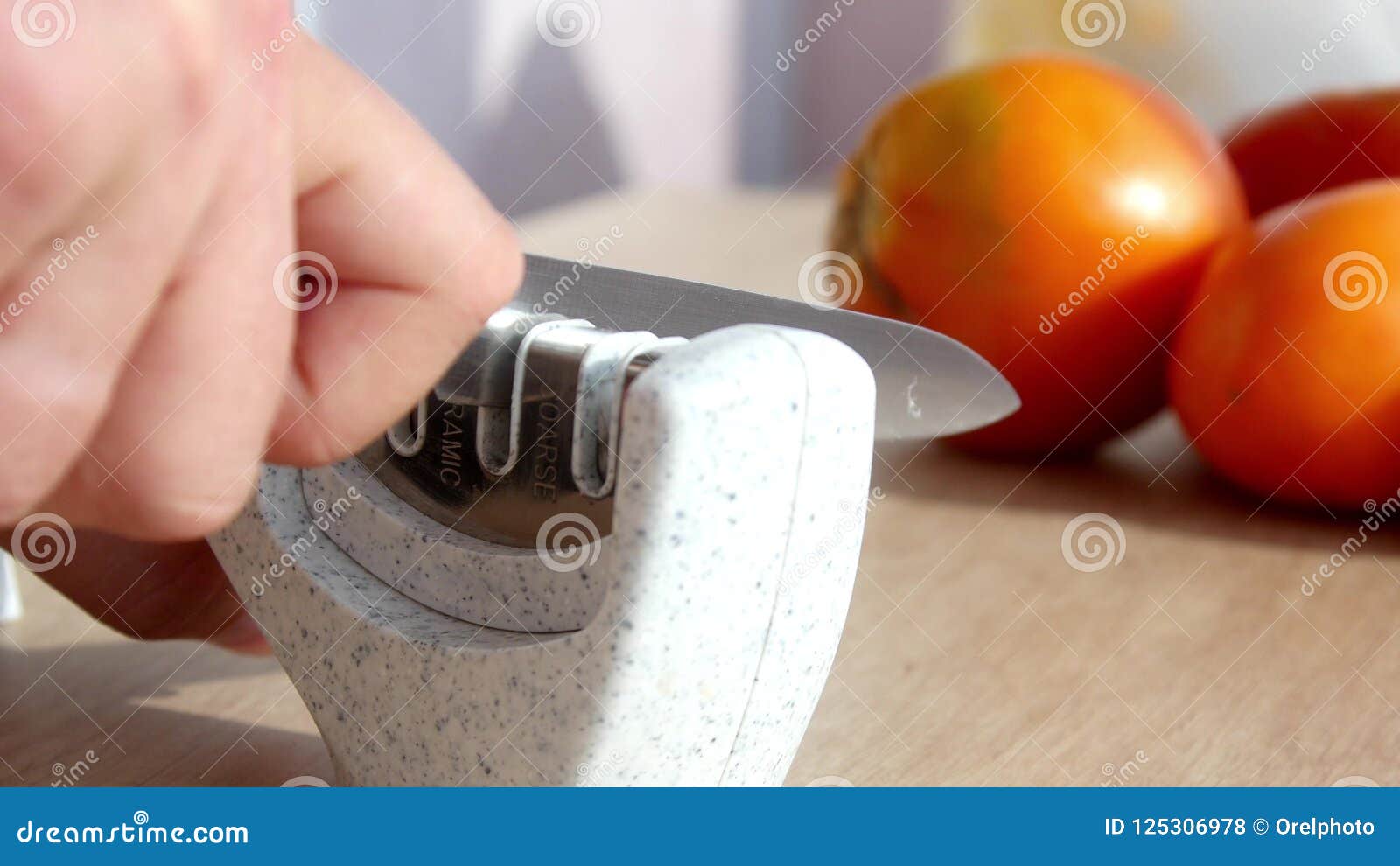 Manual Sharpening of a Knife in a Special Sharpener Stock Photo - Image ...