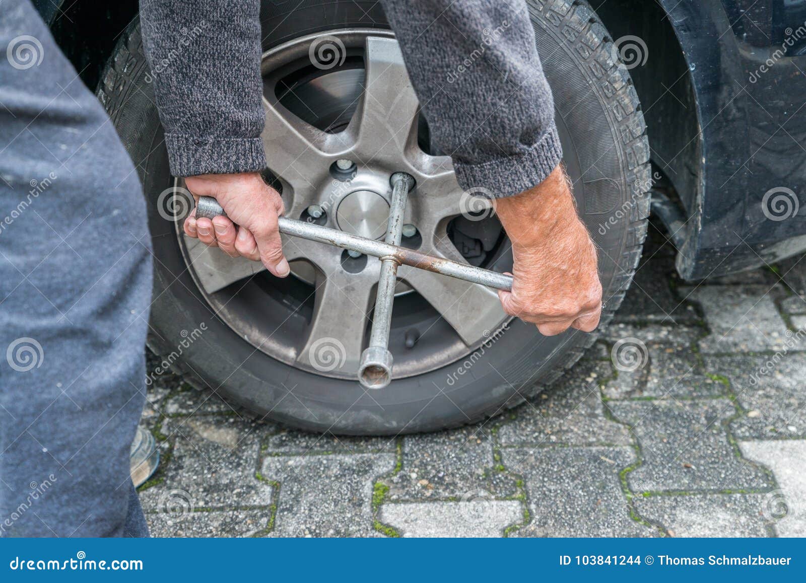 Manually Tire Change with Four-way Socket Wrench Stock Photo - Image of ...