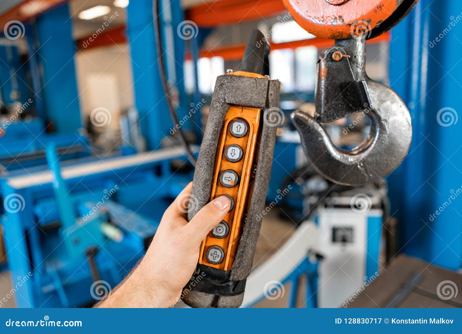 Remote Control of the Crane on Production. Workers Working with a Crane ...
