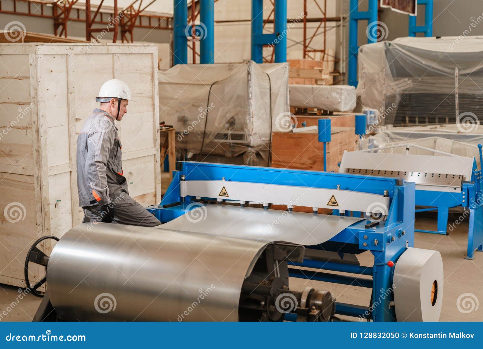 Manufacture Workshop. Workers Adjusts the Machine in the Warehouse. the ...