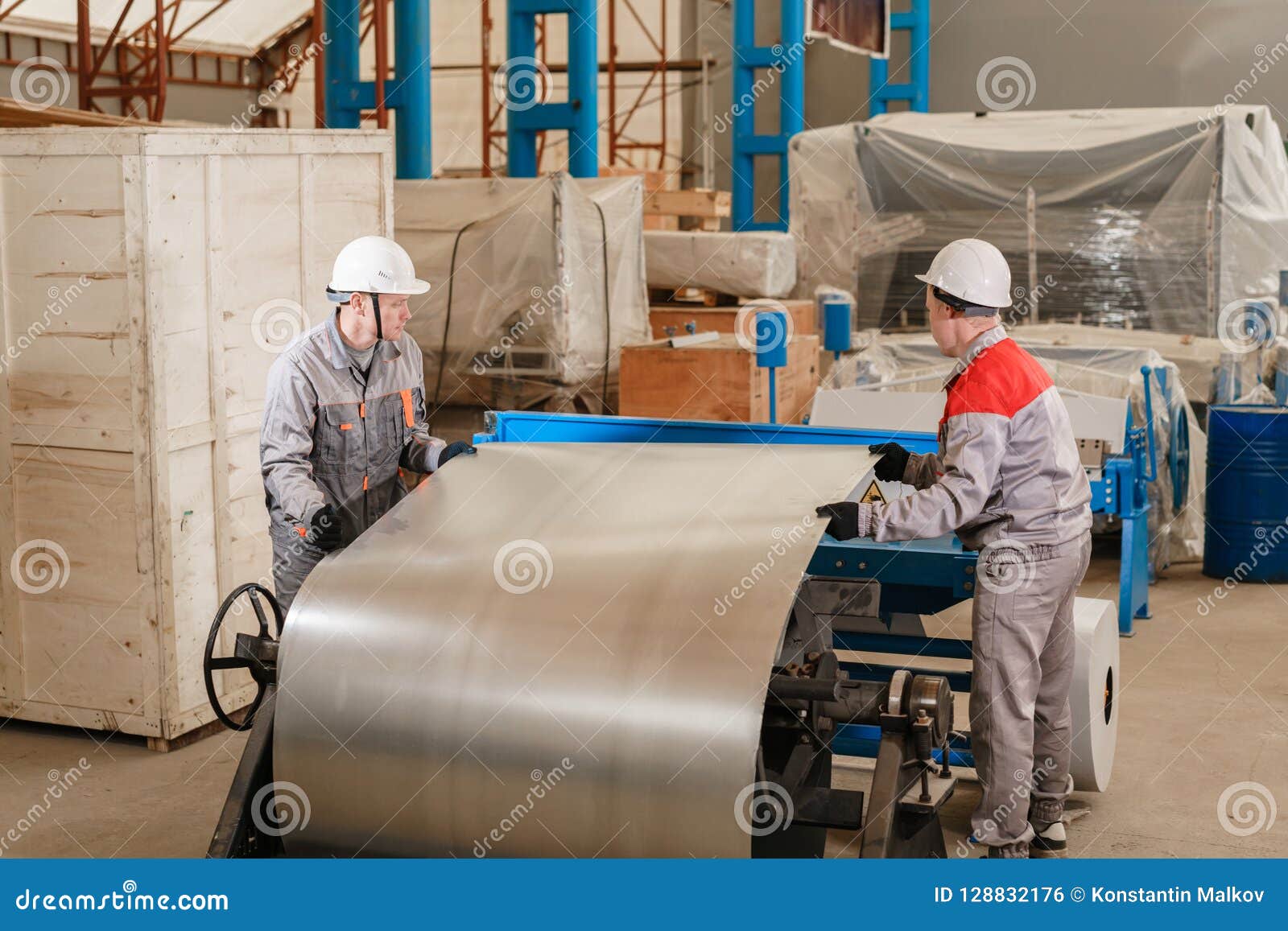 Manufacture Workshop. Workers Adjusts the Machine in the Warehouse. the ...