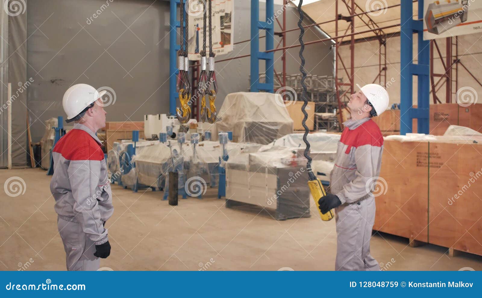 Manufacture Workshop. Workers Working with a Crane in the Warehouse ...