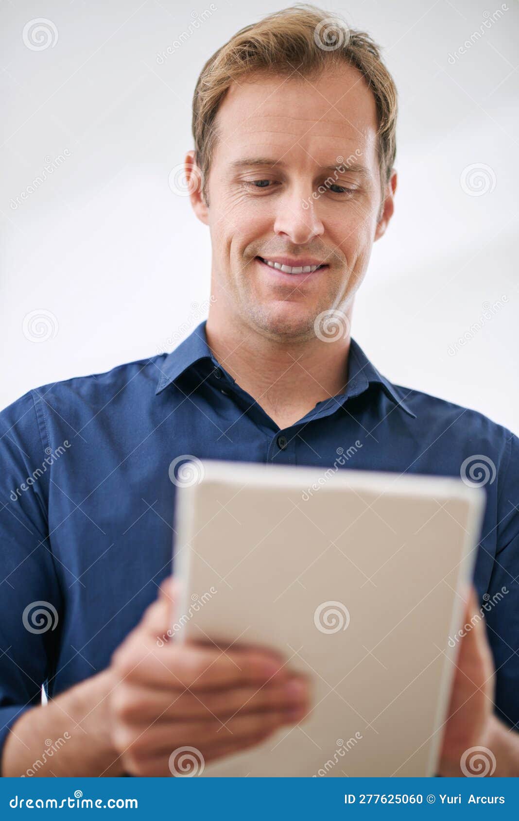 So Many Apps To Keep Him Busy. a Handsome Man Using His Tablet at Home ...