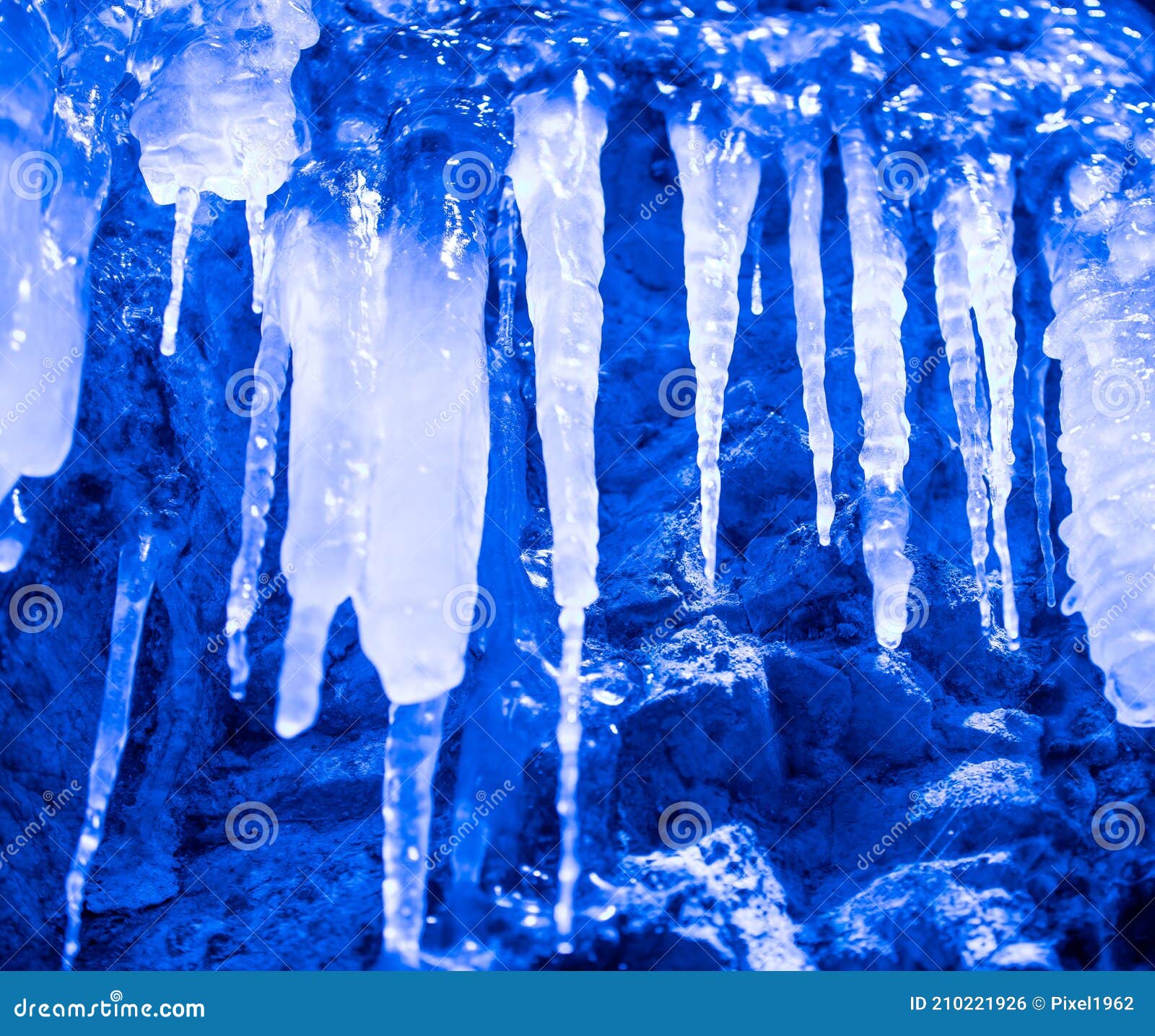 Many blue, cold Icicles stock photo. Image of frozen - 210221926
