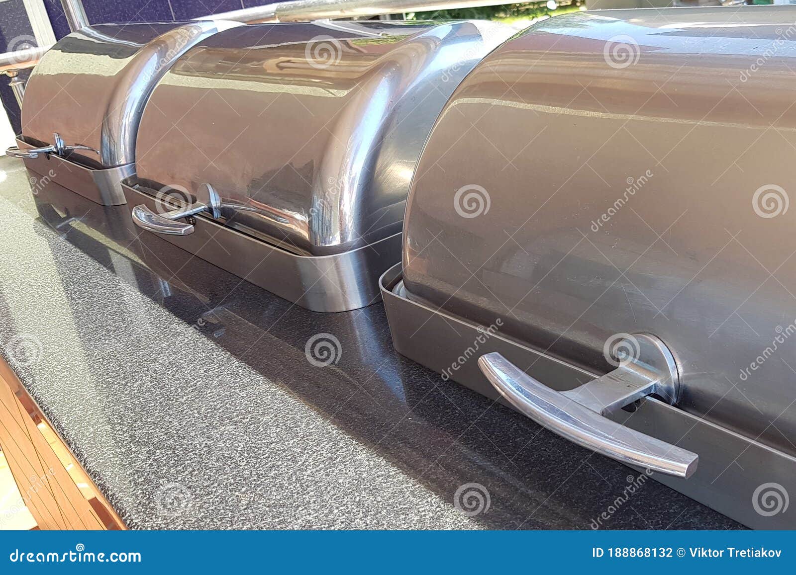Many Buffet Heated Trays Ready For Service On The Blue Table. Buffet ...