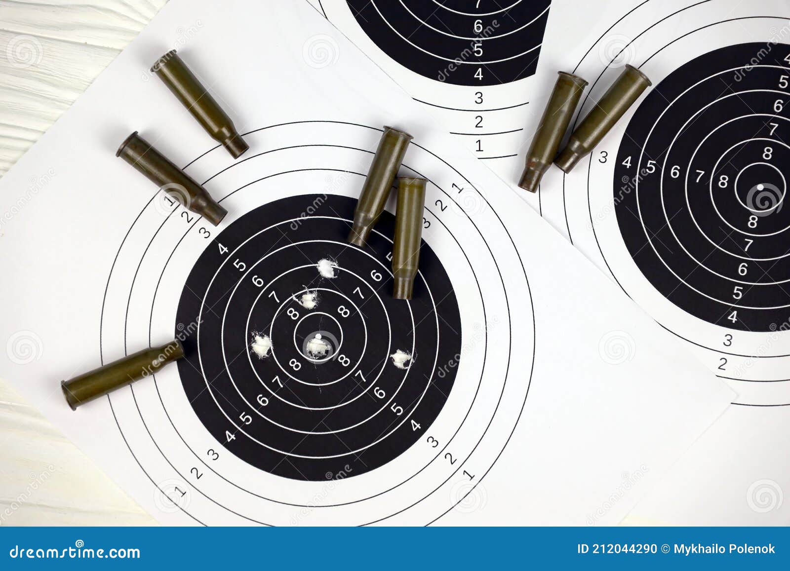Many Bullets on Shooting Targets on White Table in Shooting Range ...